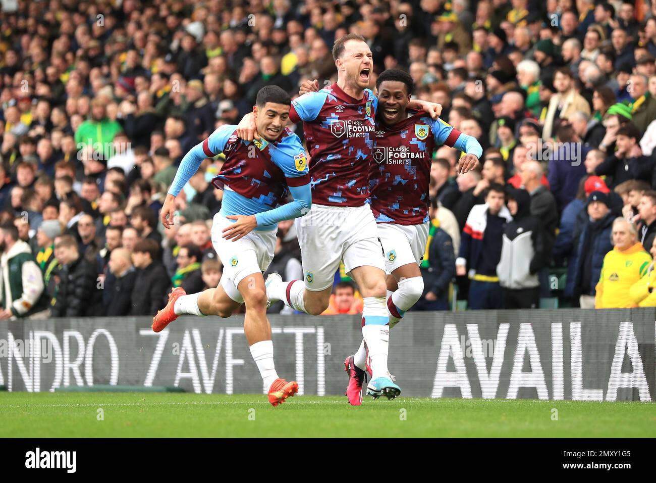 Burnley's Anass Zaroury (left) celebrates scoring their side's first ...
