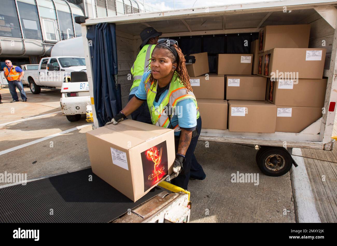 United Airline’s employee Crystal Lee, loads the Emmy boxes for the ...