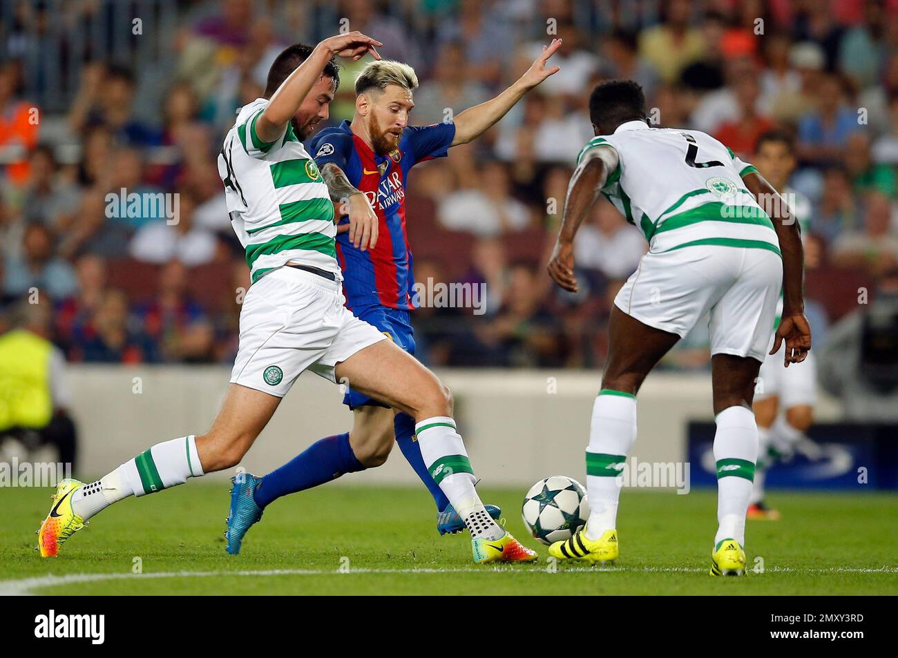 Barcelona's Lionel Messi center, makes his way through Celtic's defense ...
