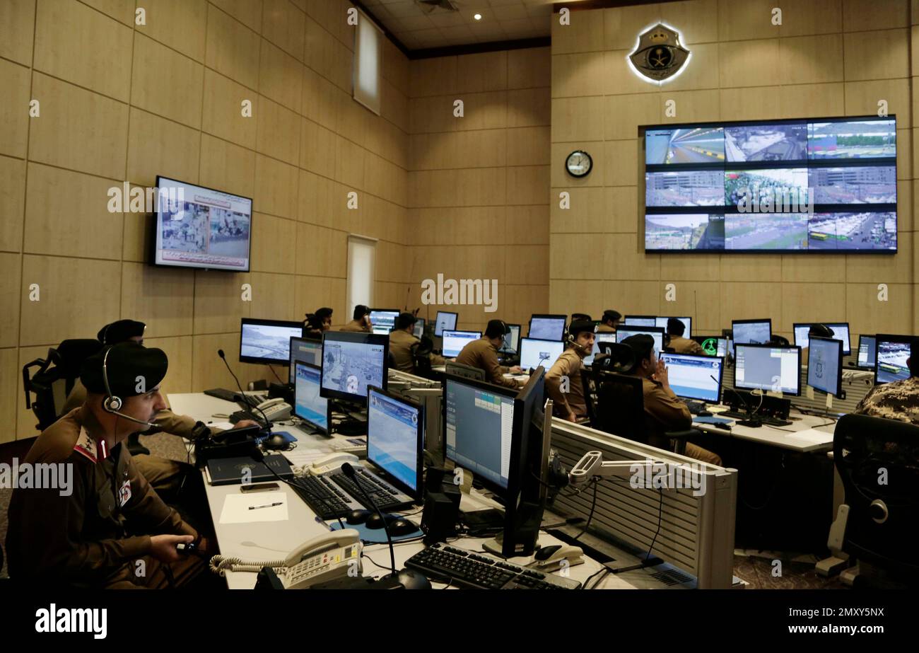 Saudi security officers monitor live feed screens showing Muslim ...