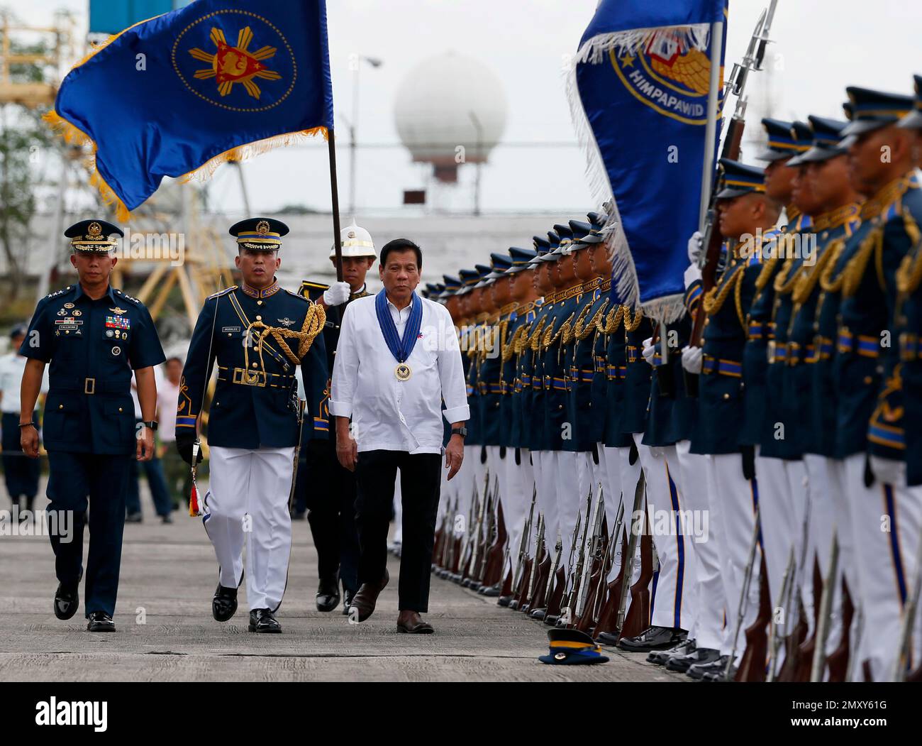 A hat falls as Philippine President Rodrigo Duterte reviews the troops ...