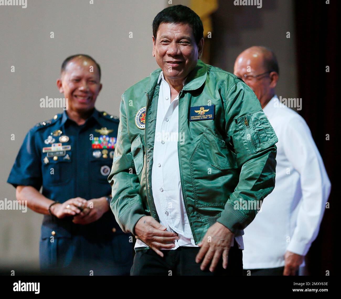 Philippine President Rodrigo Duterte, center, smiles as he is presented ...