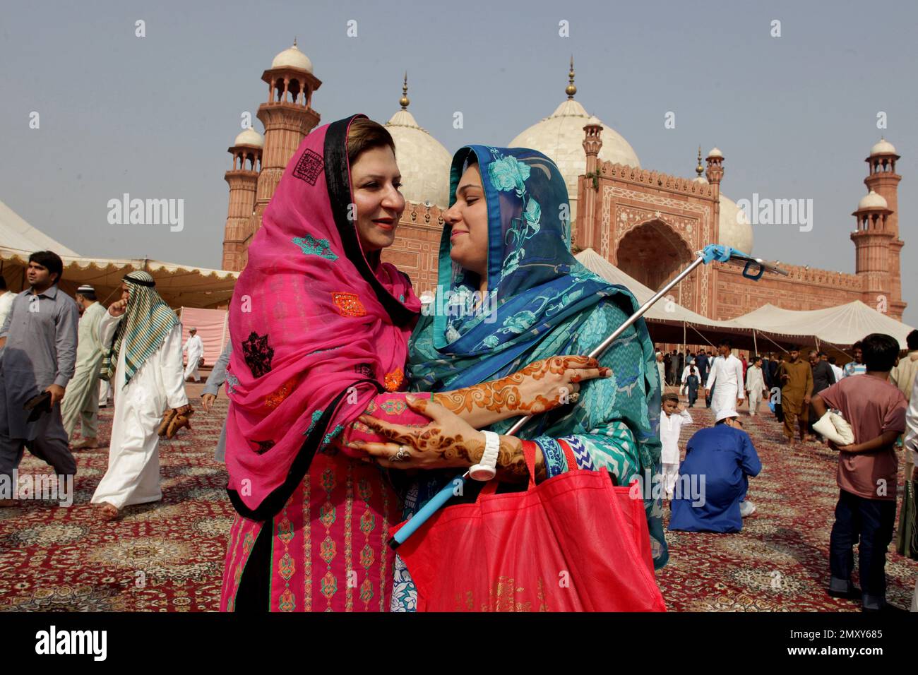 Pakistani Muslim women greet each other after offering Eid al Adha ...