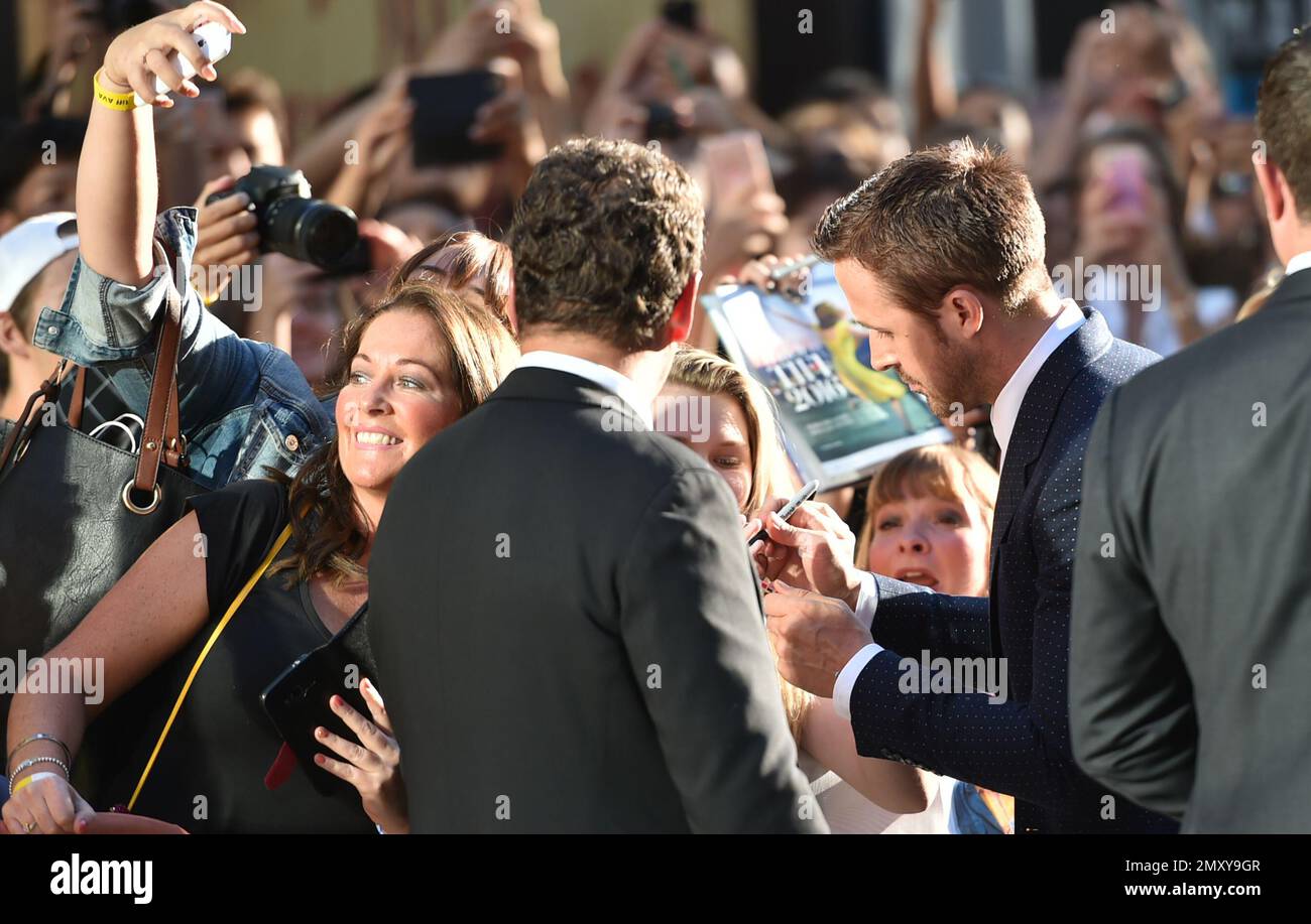 Ryan Gosling signs autographs as he arrives at the "La La Land ...
