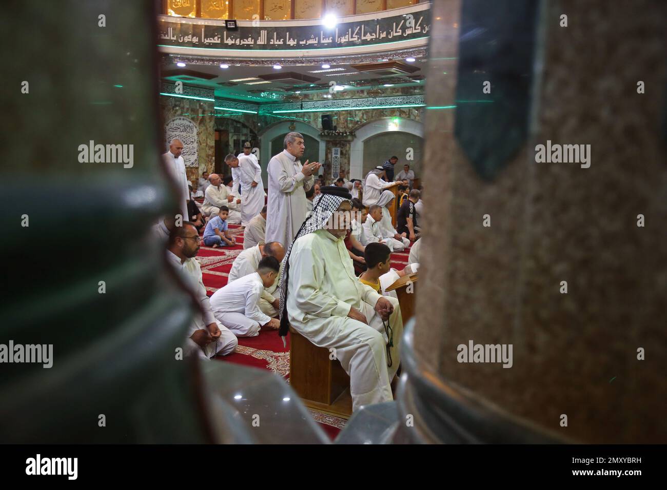Iraqi Shia Muslims attend prayers on the first day of Eid al-Adha at ...