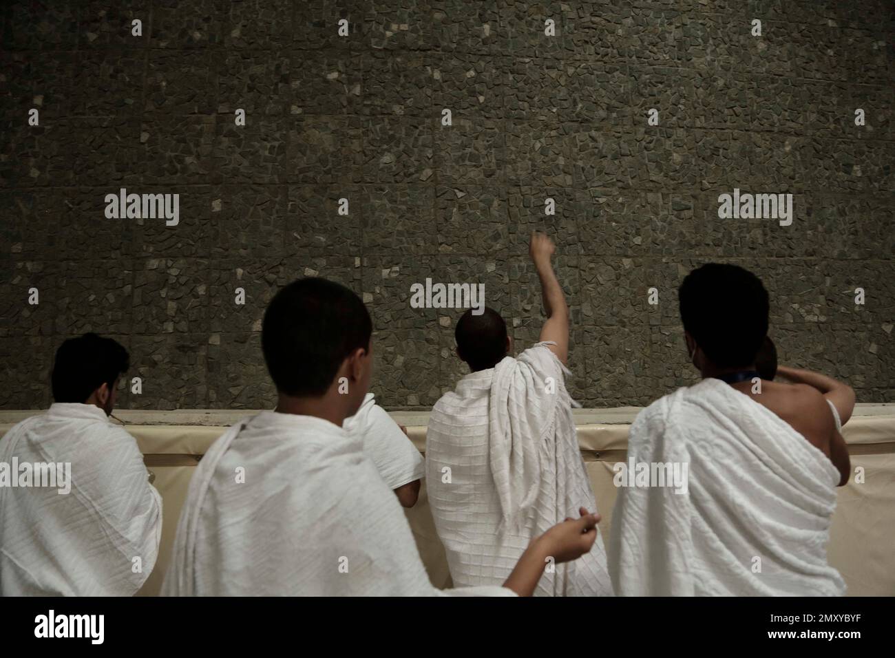 Saudi Muslim pilgrims cast stones at a pillar symbolizing the stoning ...