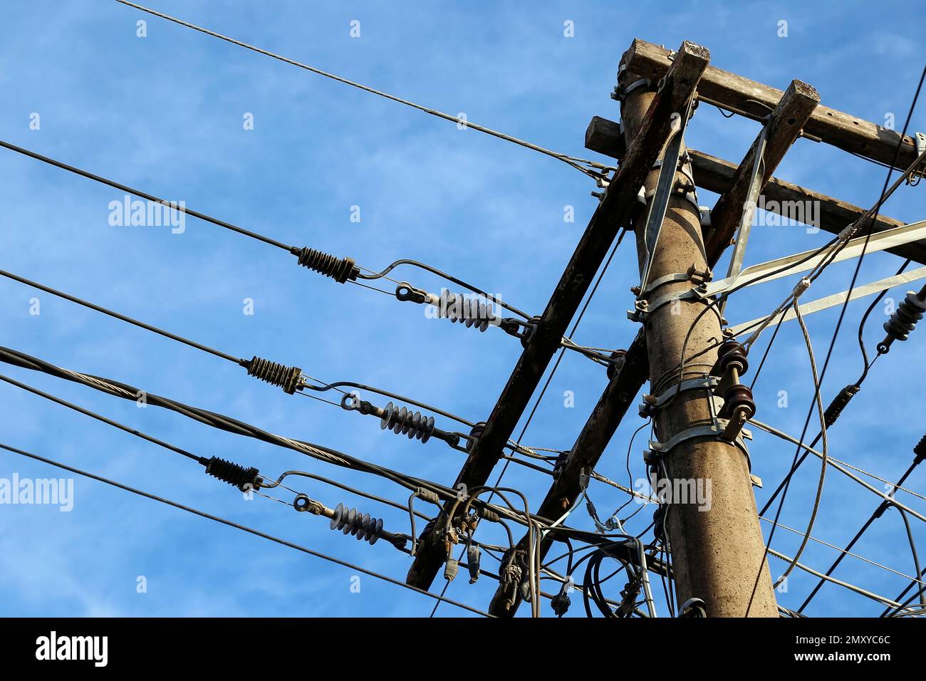 concrete pole with electrical power, telephony and fiber optic cabling ...