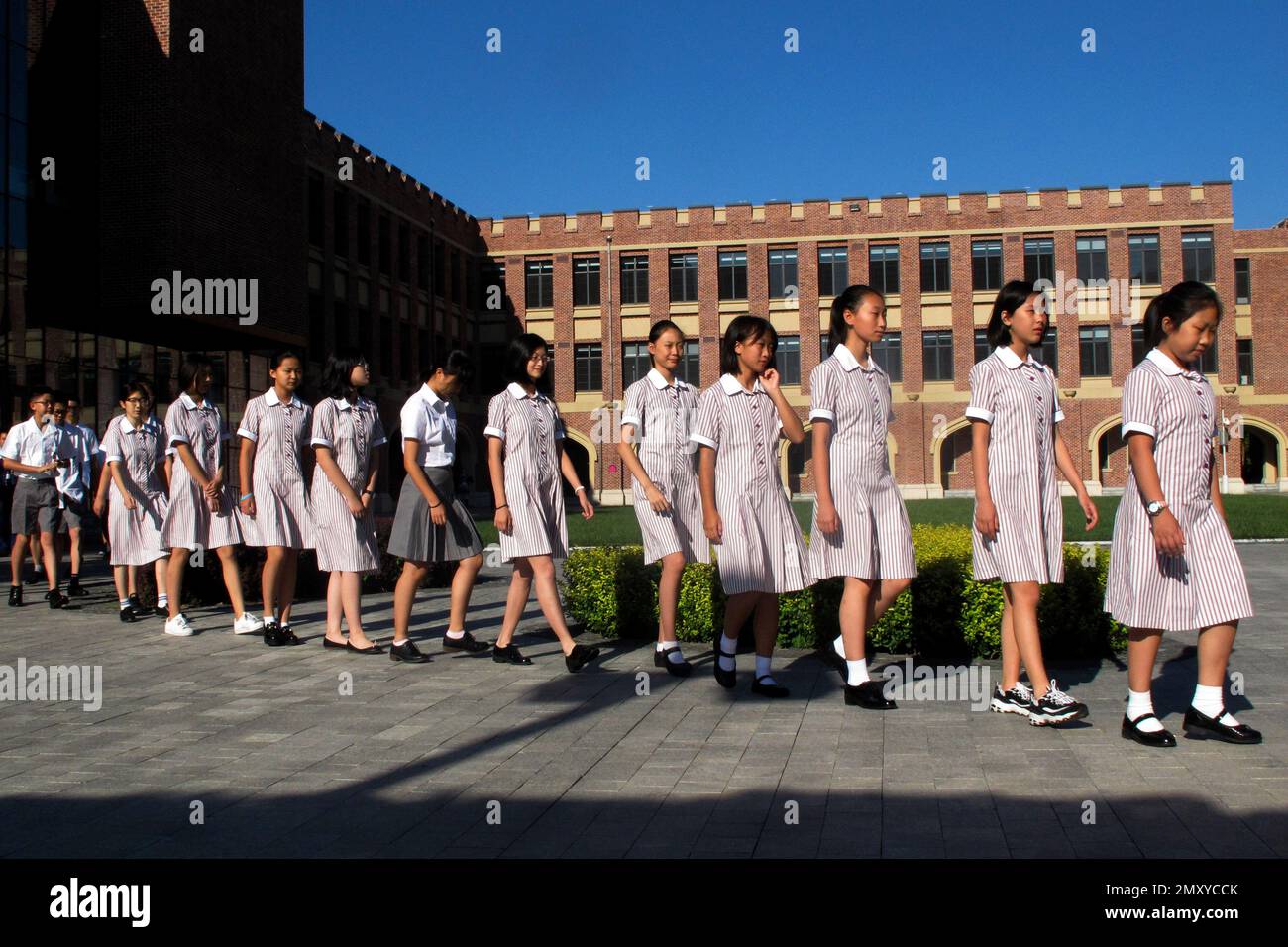 In this Aug. 31, 2016 photo, Chinese students walk in line to attend ...