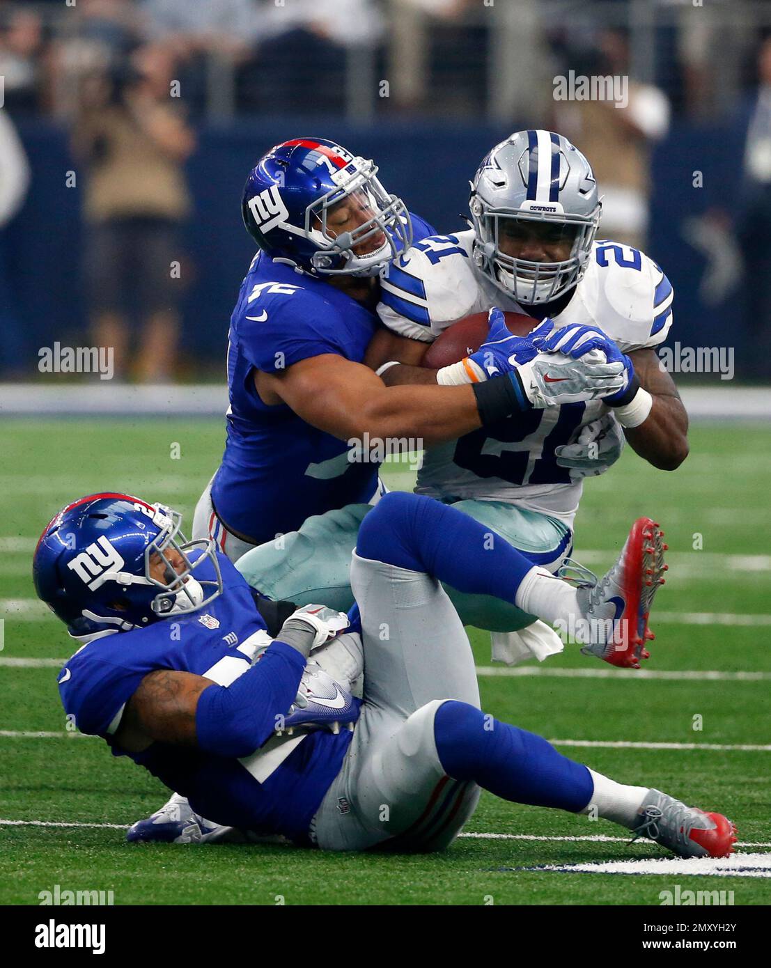 New York Giants safety Darian Thompson, bottom, and defensive end Kerry ...