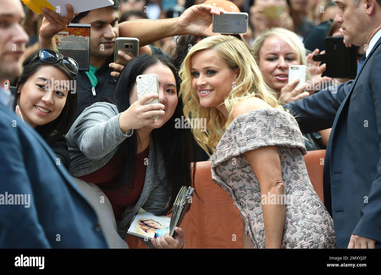 Reese Witherspoon takes a selfie with fans as she arrives at the "Sing ...