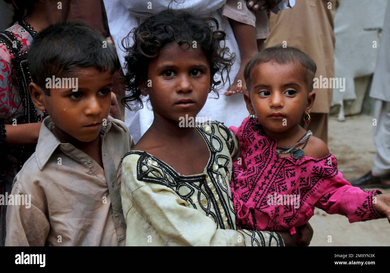 Ethnic Pakistani Sheedi children watch dancers during the alligator ...