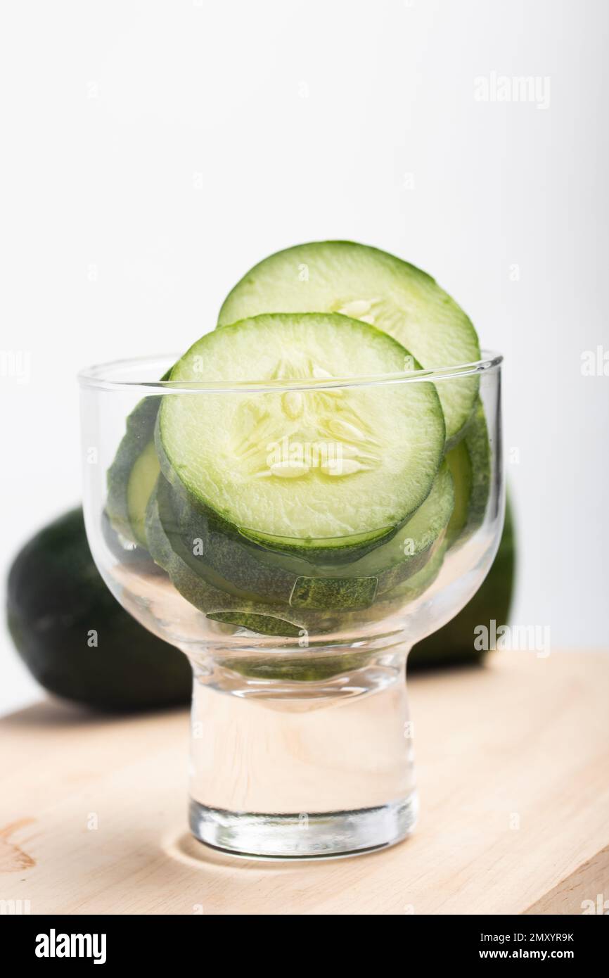 Sliced cucumbers in a transparent cup on a white background Stock Photo ...