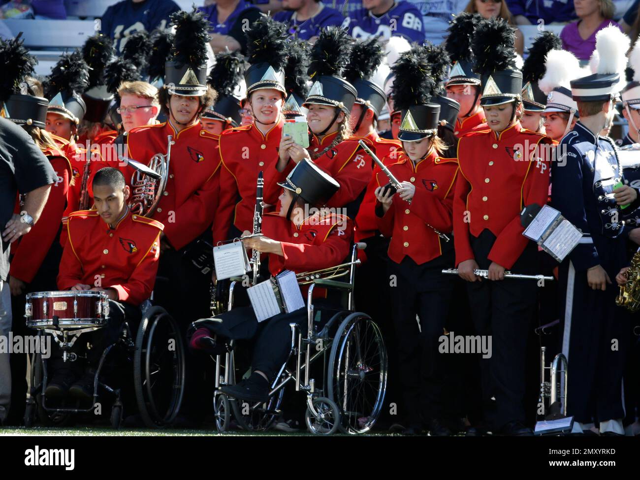 Members of the Franklin Pierce High School band wait to take the field ...