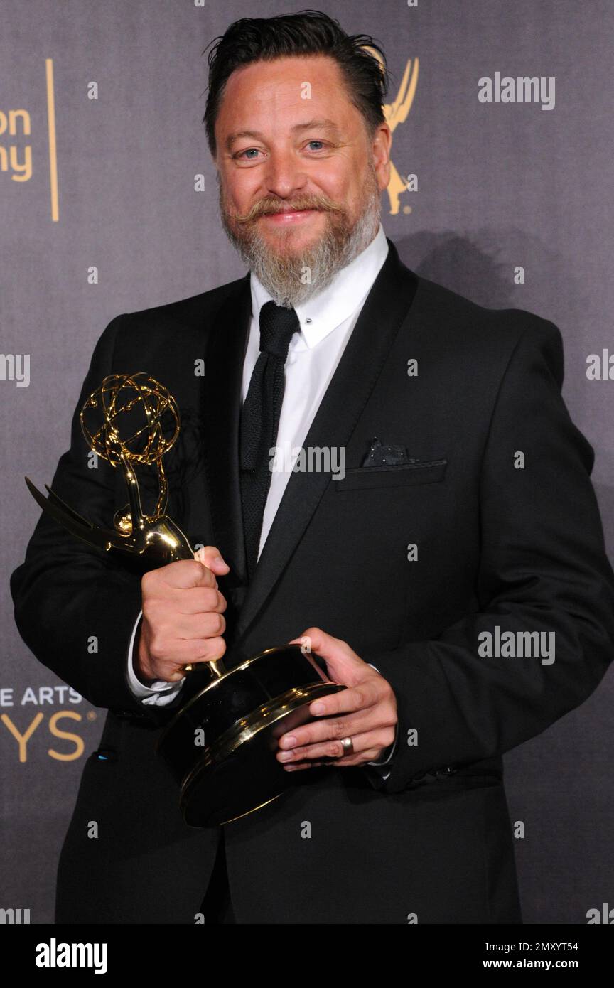 Tim Porter poses in the press room with the award for outstanding ...