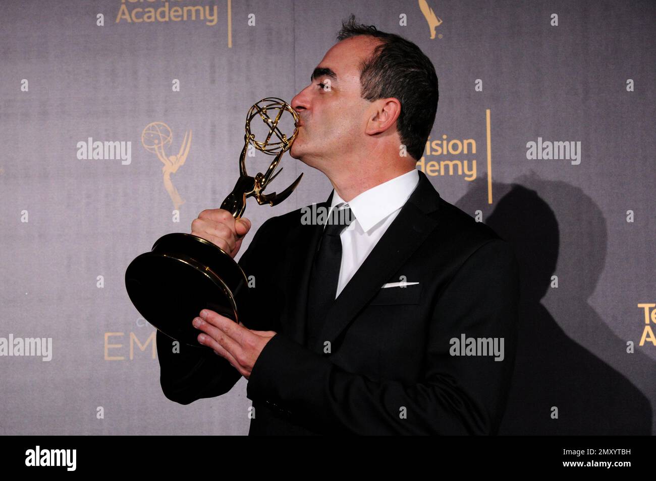 Victor Reyes poses in the press room with the award for outstanding ...