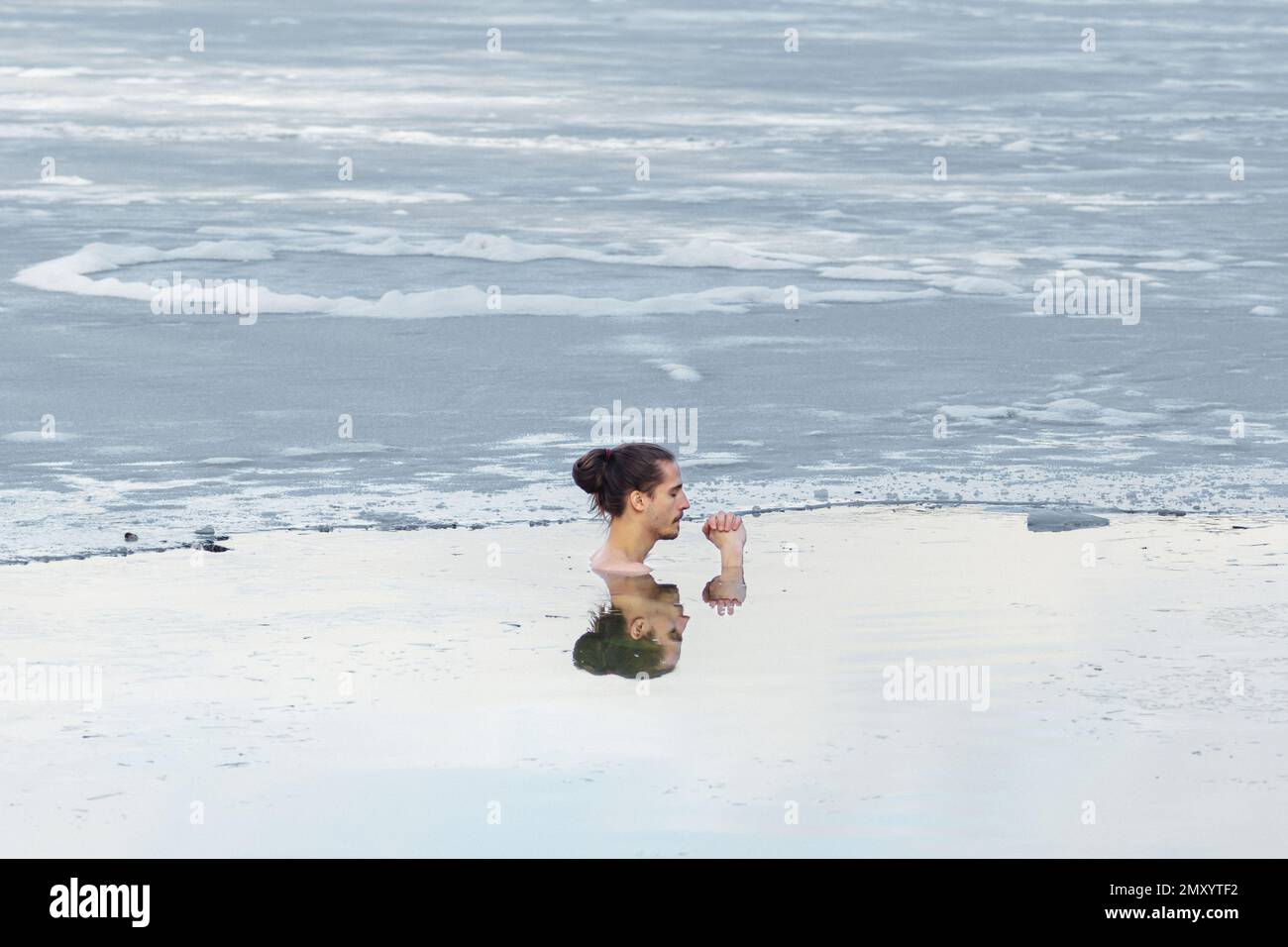 Handsome boy or man ice bathing in the cold water of a lake. Wim Hof ...