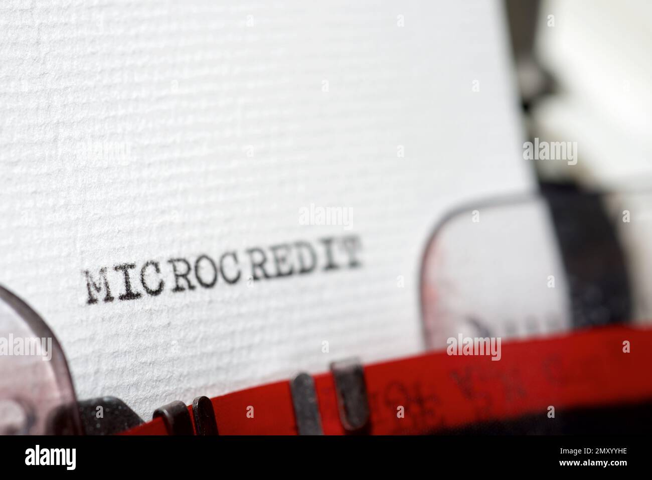 Microcredit word written with a typewriter Stock Photo - Alamy