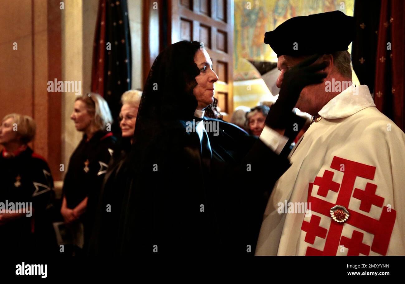 Judy Piper adjusts the hat of her husband Terry Piper as members of the ...
