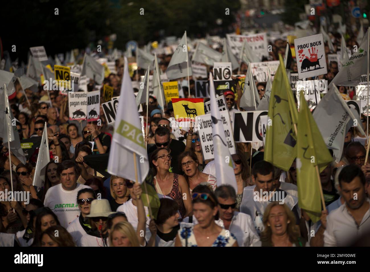 People shout slogans as they march during a protest against ...