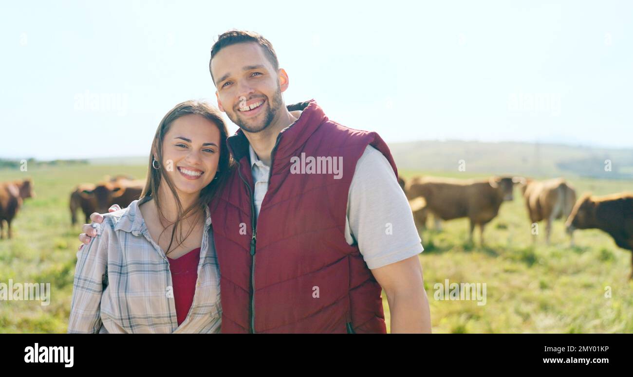 Cow, love and happy couple on a cattle farm hugging, bonding and enjoy ...