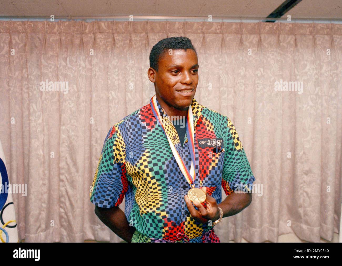 Carl Lewis of Houston, Texas, wears the Olympic gold medal which had ...