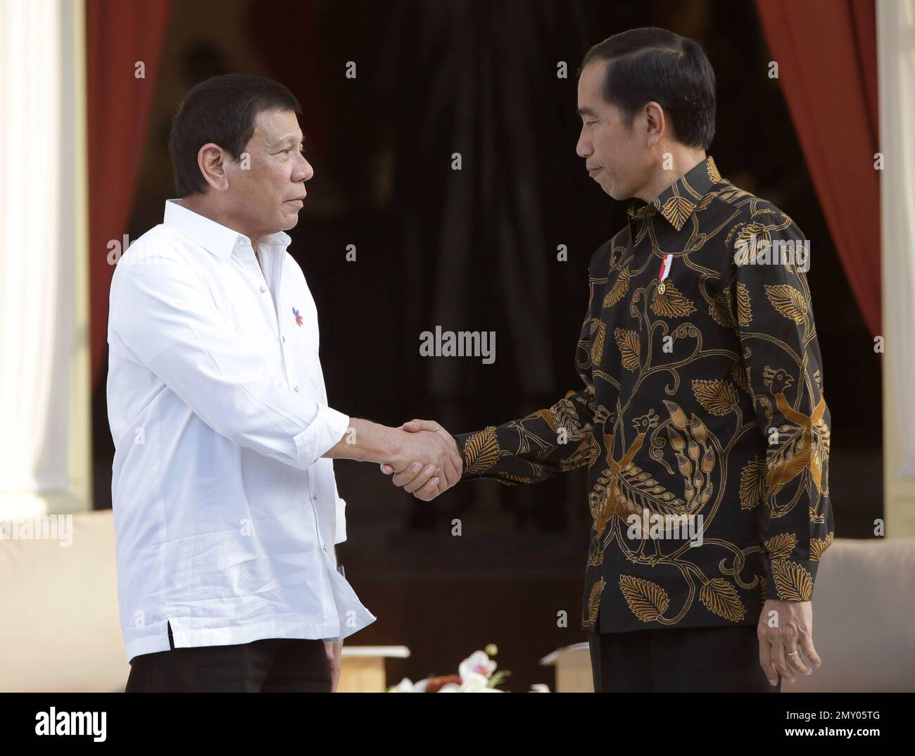 Philippine President Rodrigo Duterte, left, shake hands with his ...