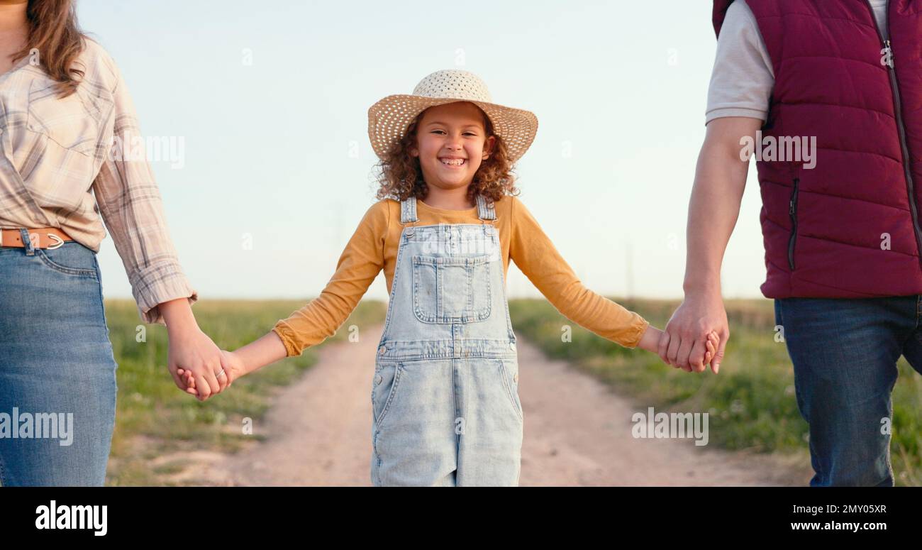 Agriculture, farming and family holding hands on farm in summer ...