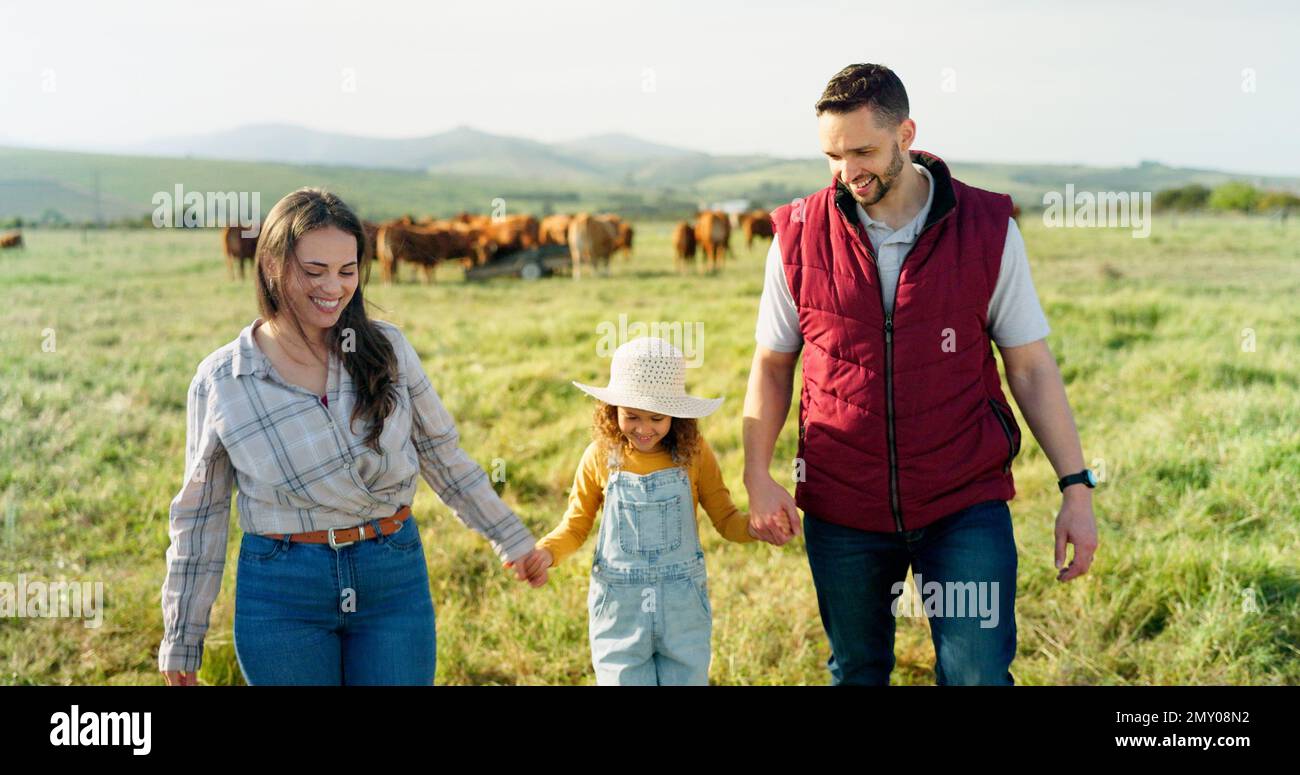 Farm, family and cattle with a girl, mother and father walking on a ...