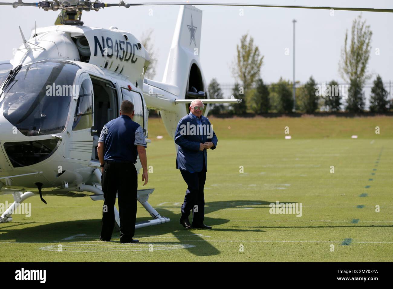 Dallas Cowboys team owner Jerry Jones, right, walks off his customized ...