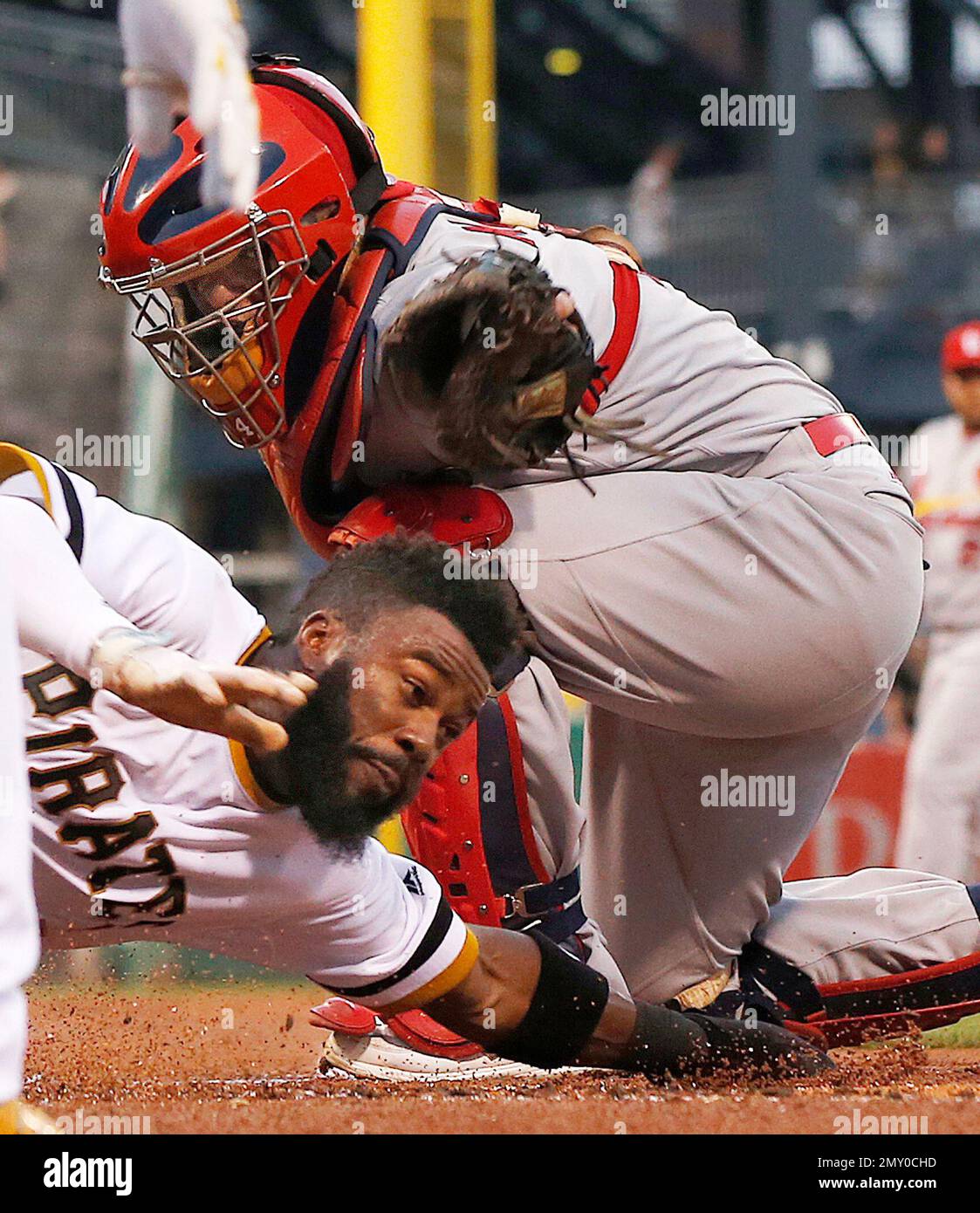 Pittsburgh Pirates' Josh Harrison, bottom, scores around the tag of St ...
