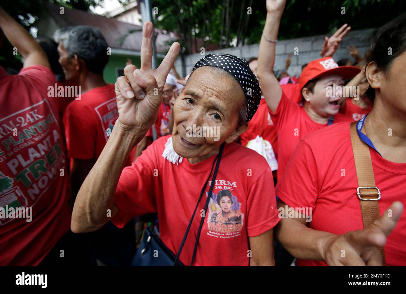 Supporters of the late strongman Ferdinand Marcos flashes the "V" sign ...
