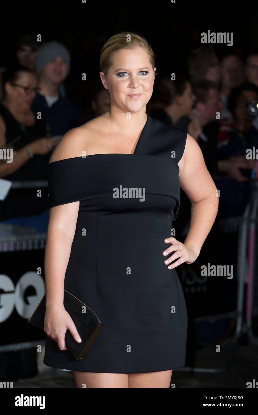 Comedian Amy Schumer poses for photographers upon arrival at the GQ ...