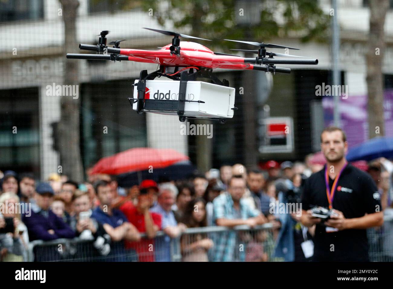 A drone holds a box during an exhibition flight in Paris, Sunday, Sept ...