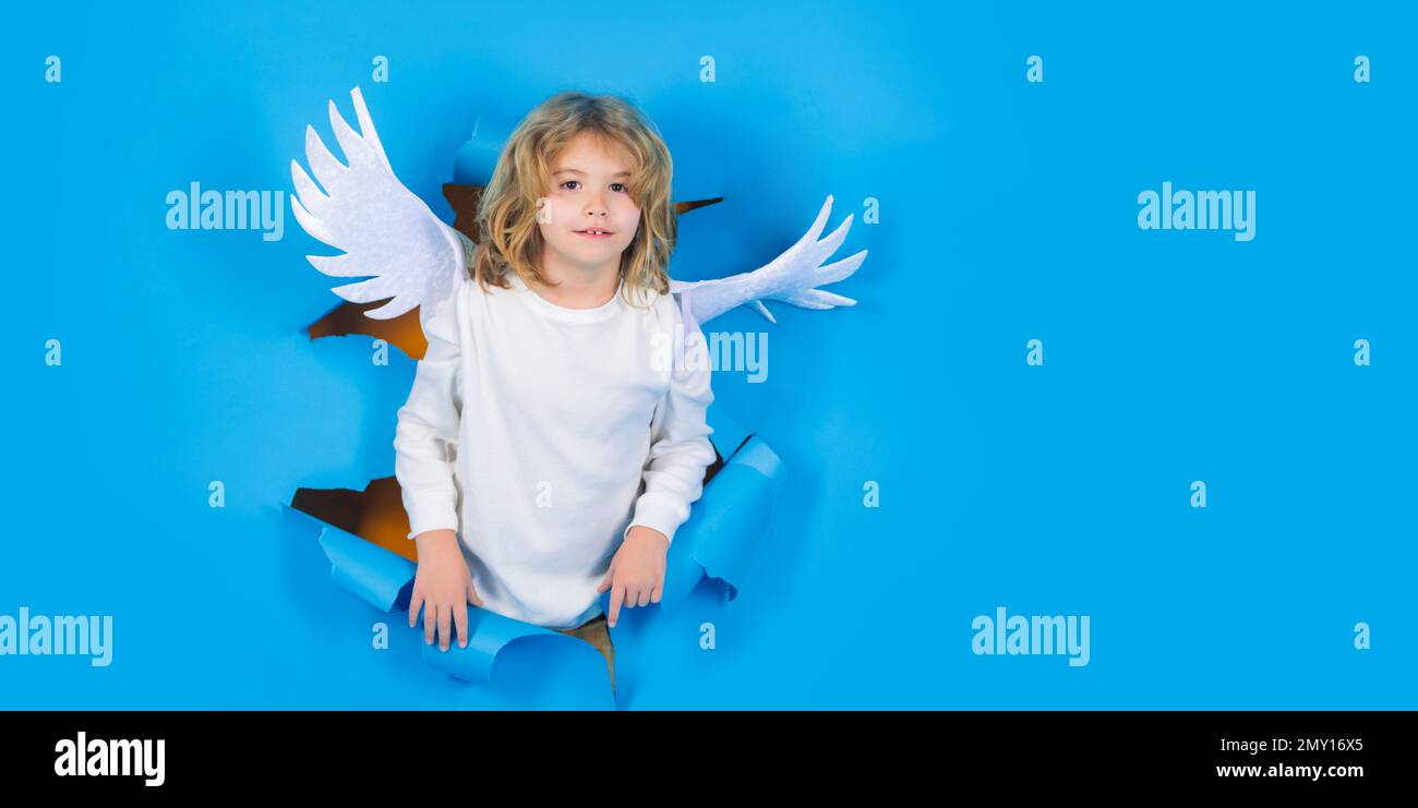 Valentine day. Little child angel in paper hole. Portrait of cute kid ...