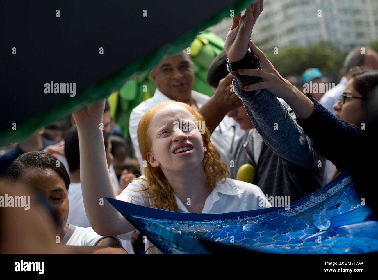 Visually disabled students touch the sculpture of Agitos, symbol of the ...