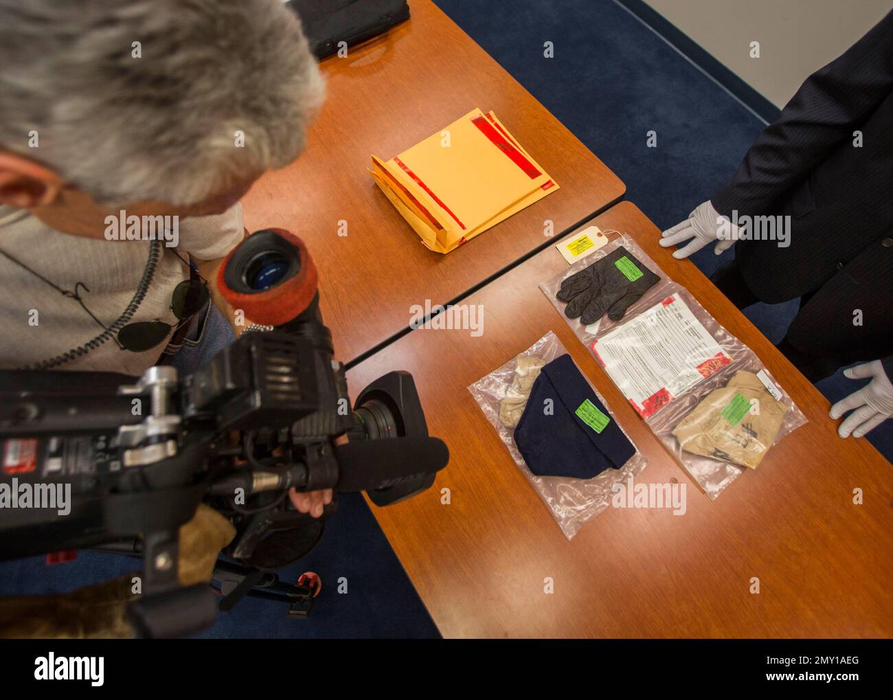 A videographer tapes a glove and a hat used as evidence in the O.J ...