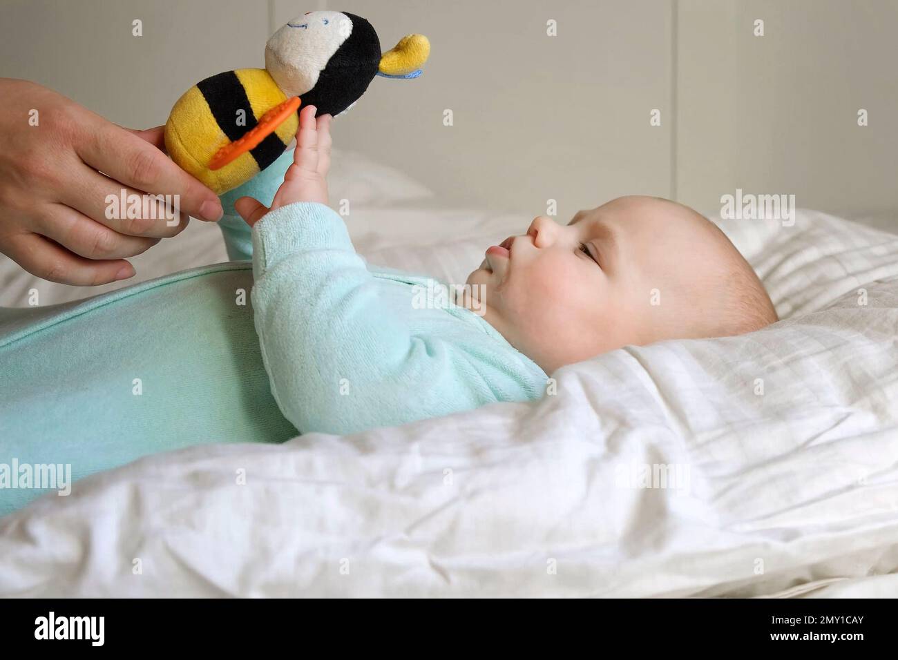 Cute Newborn Baby Lying on the Back and Plays with Colorful Toys ...