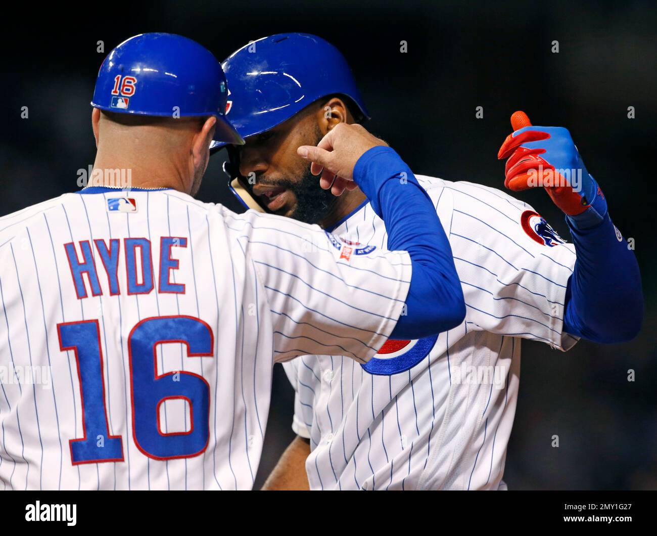 Chicago Cubs' Jason Heyward, right, celebrates with first base coach ...