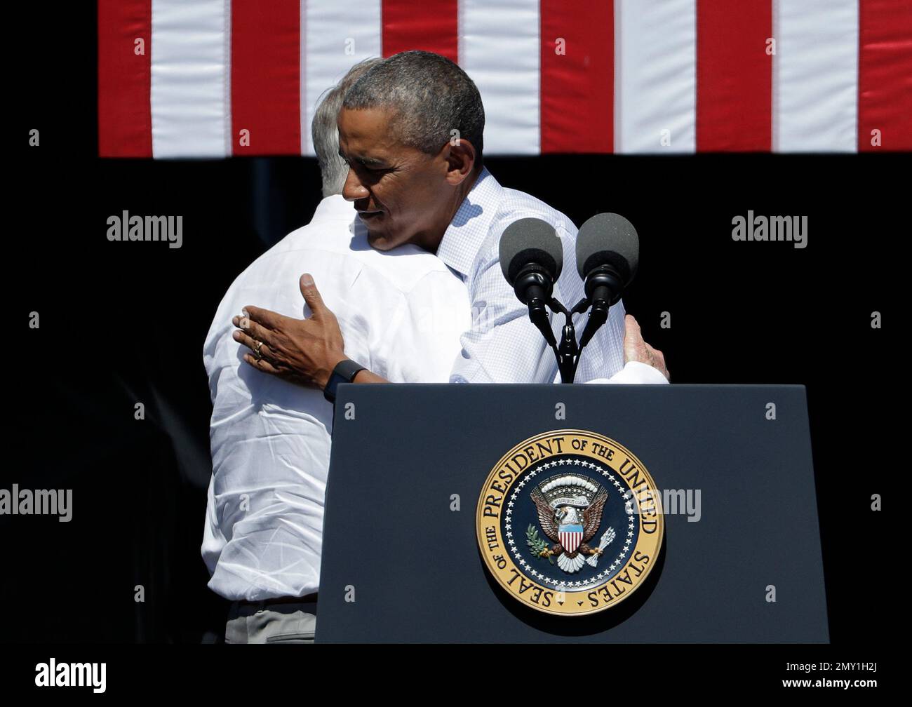 President Barack Obama, right, embraces Senate Minority Leader Harry ...