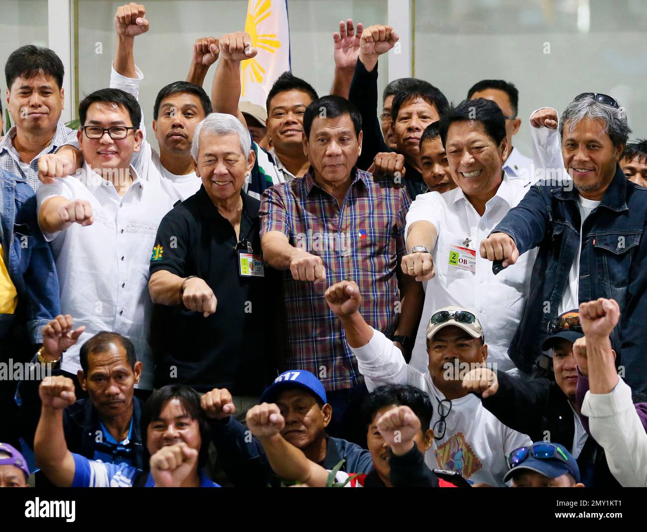 Philippine President Rodrigo Duterte, center, gestures with a fist bump ...