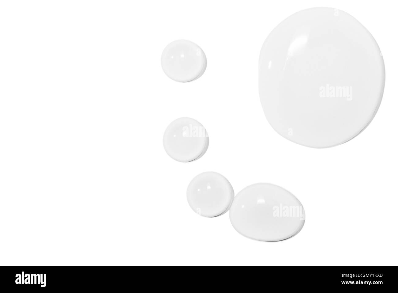 large drops of transparent gel or serum or water, on a white background ...