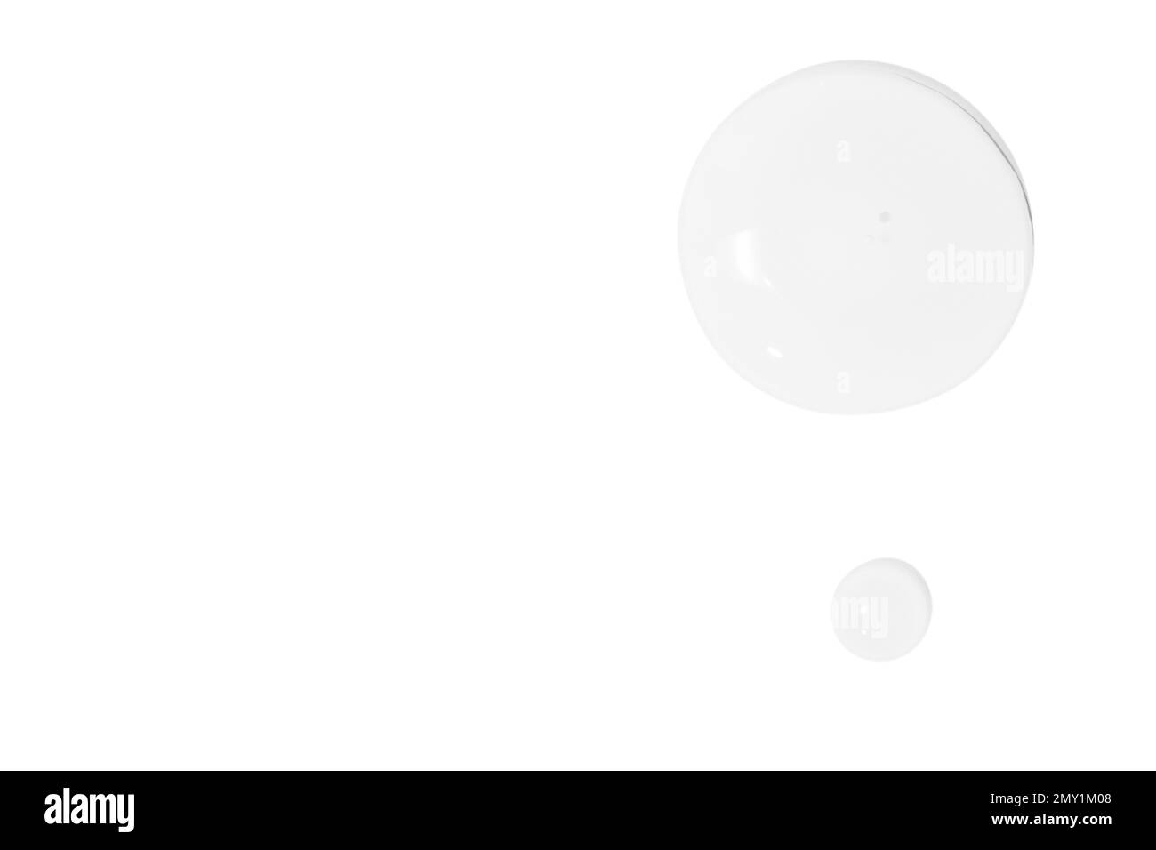 large drops of transparent gel or serum or water, on a white background ...