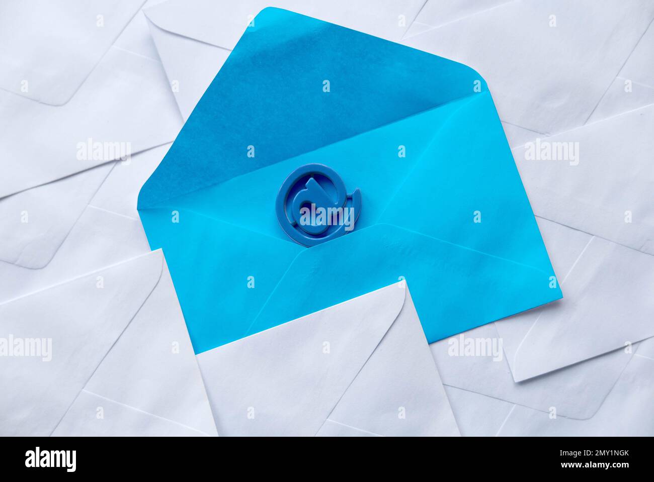 Email marketing concept. An open blue envelope and email address symbol ...