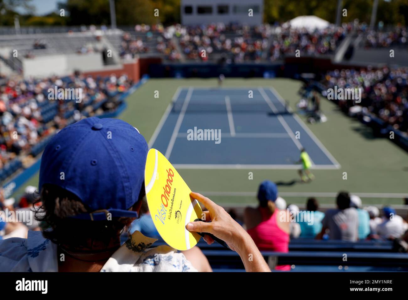 A spectator shades his face from the sun while watching the first round ...