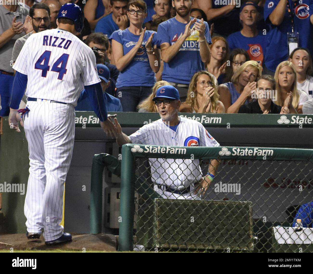 Chicago Cubs' Anthony Rizzo (44) is greeted by Cubs manager Joe Maddon ...