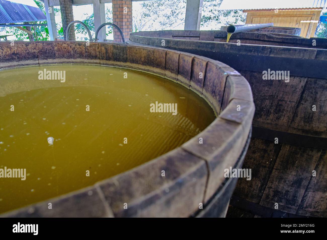 Part of the traditional process of distilling brandy from sugar cane, a ...