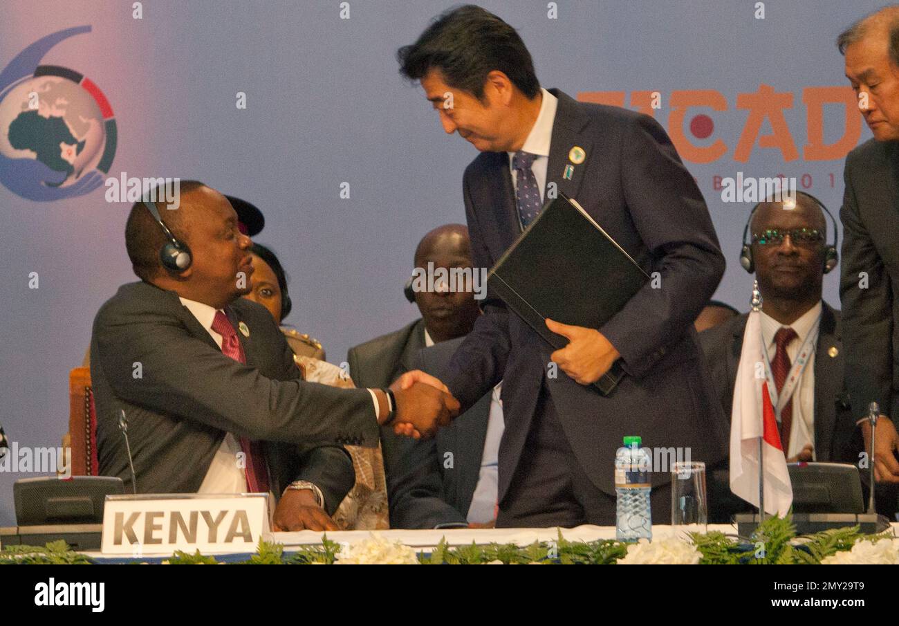 Japanese Prime Minister Shinzo Abe, right, shakes hands with Kenyan ...