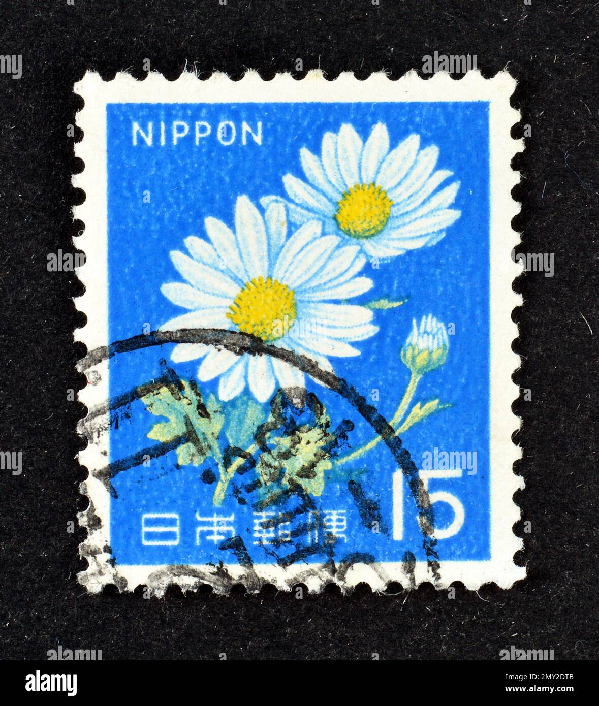Cancelled postage stamp printed by Japan, that shows Ox-eye Daisy ...