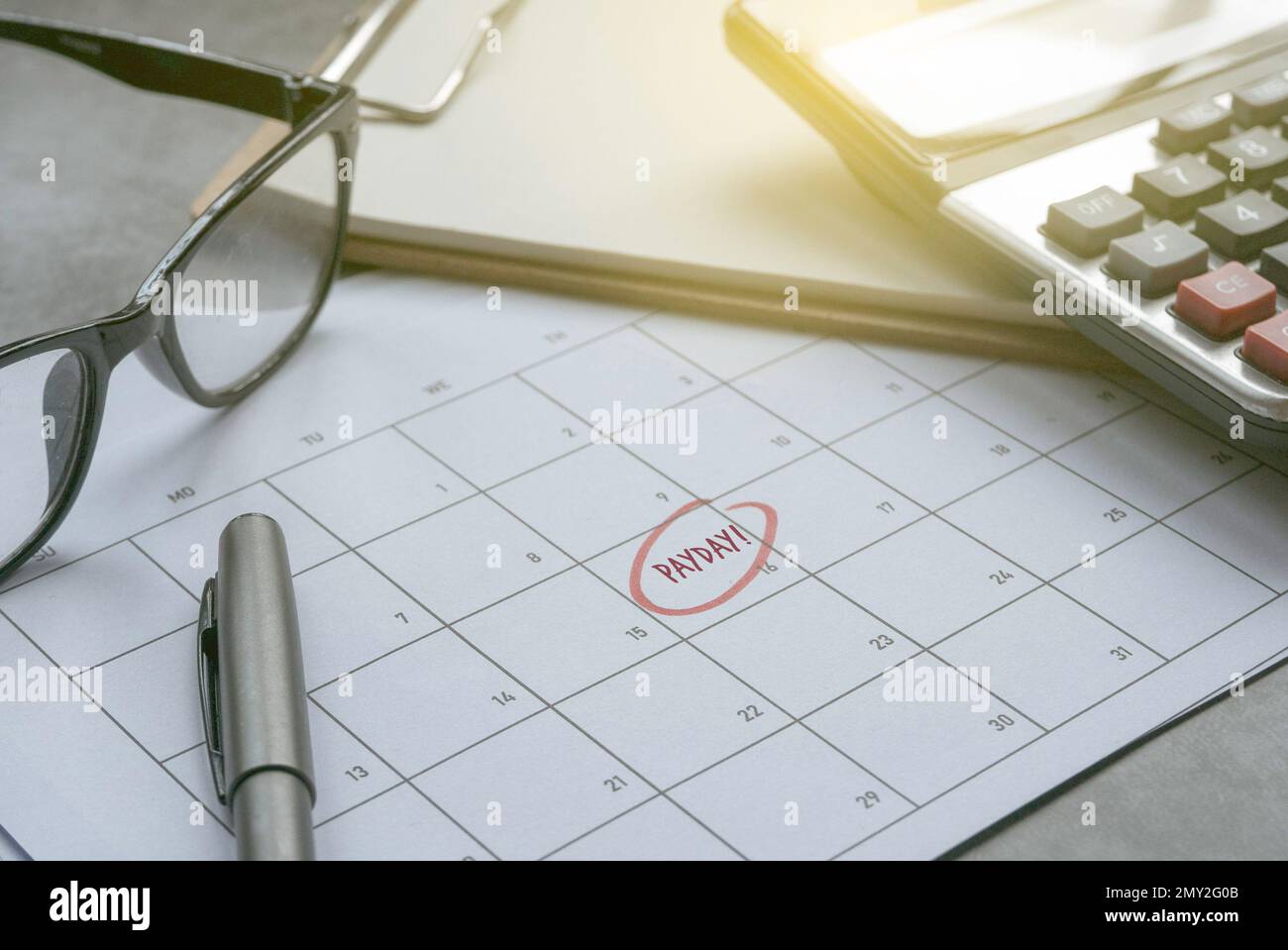 Payroll and payday concept with calculator and calendar Stock Photo - Alamy