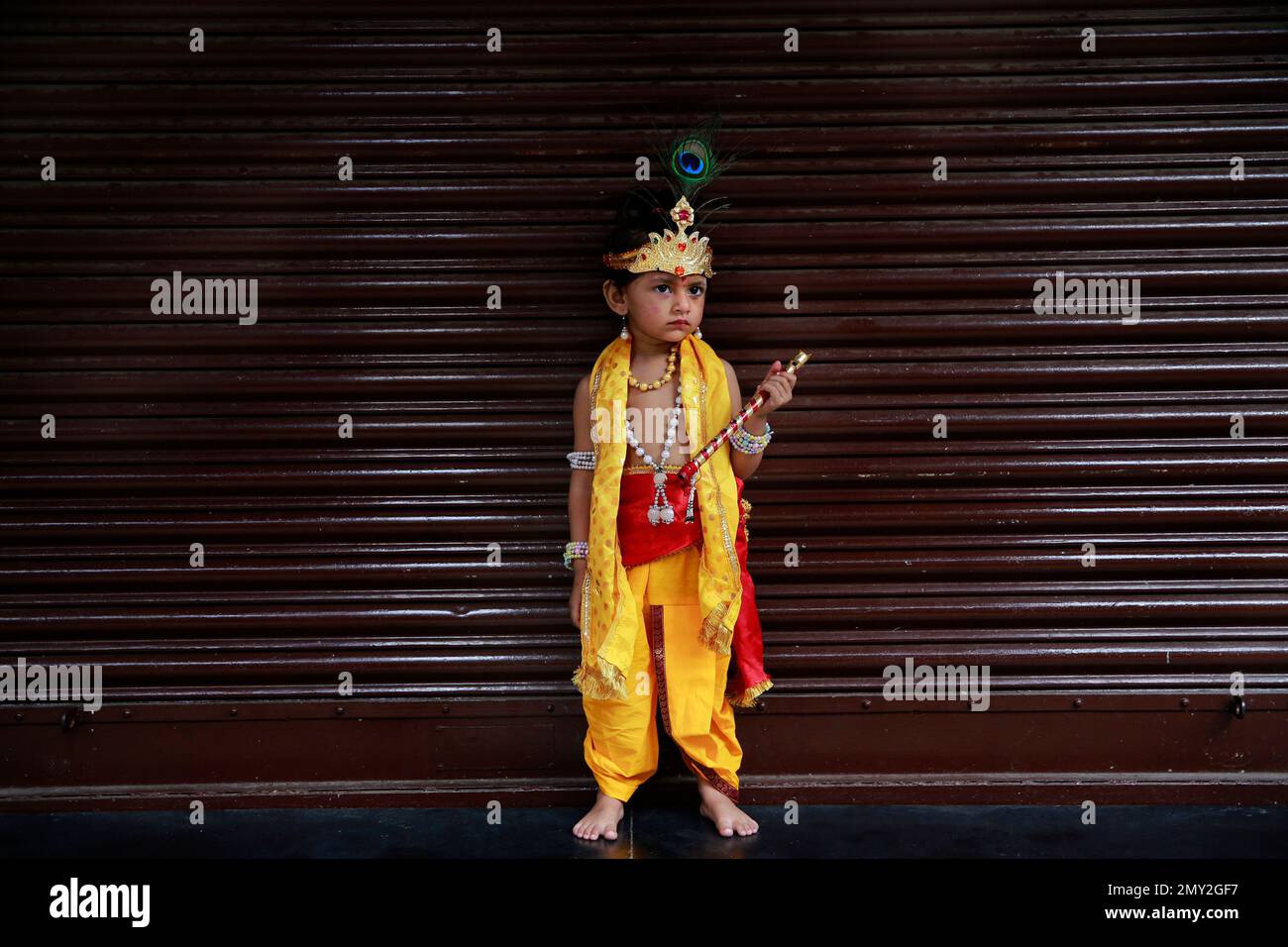 A boy dressed as Hindu Lord Krishna participates in the Janmashtami ...